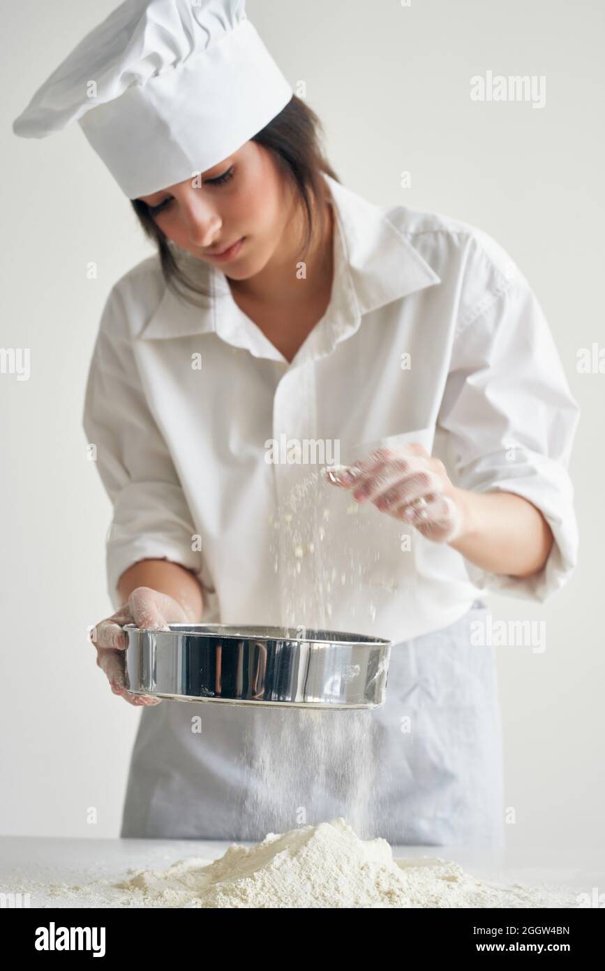 woman chef sifting flour on the table bakery cooking pastry Stock Photo ...