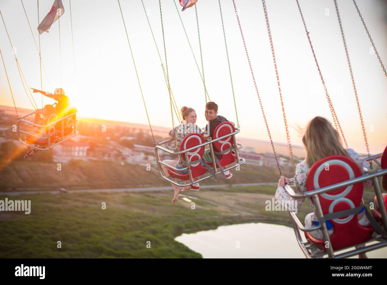 People have fun enjoying the air carousel in the amusement park Stock ...