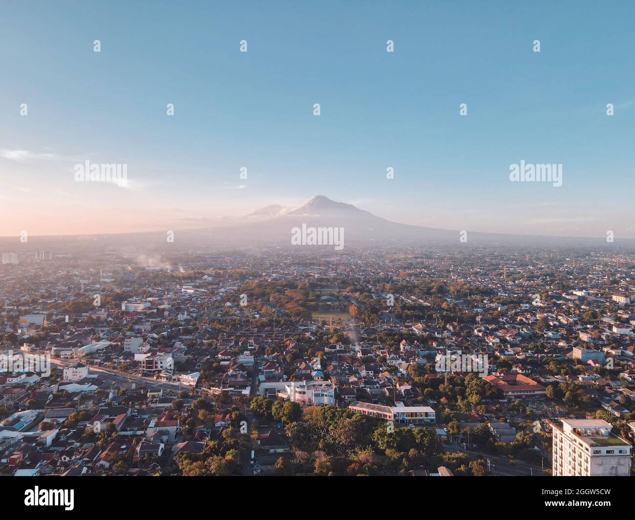 Aerial view of sunset Mount Merapi and Yogyakarta city, Indonesia. City ...