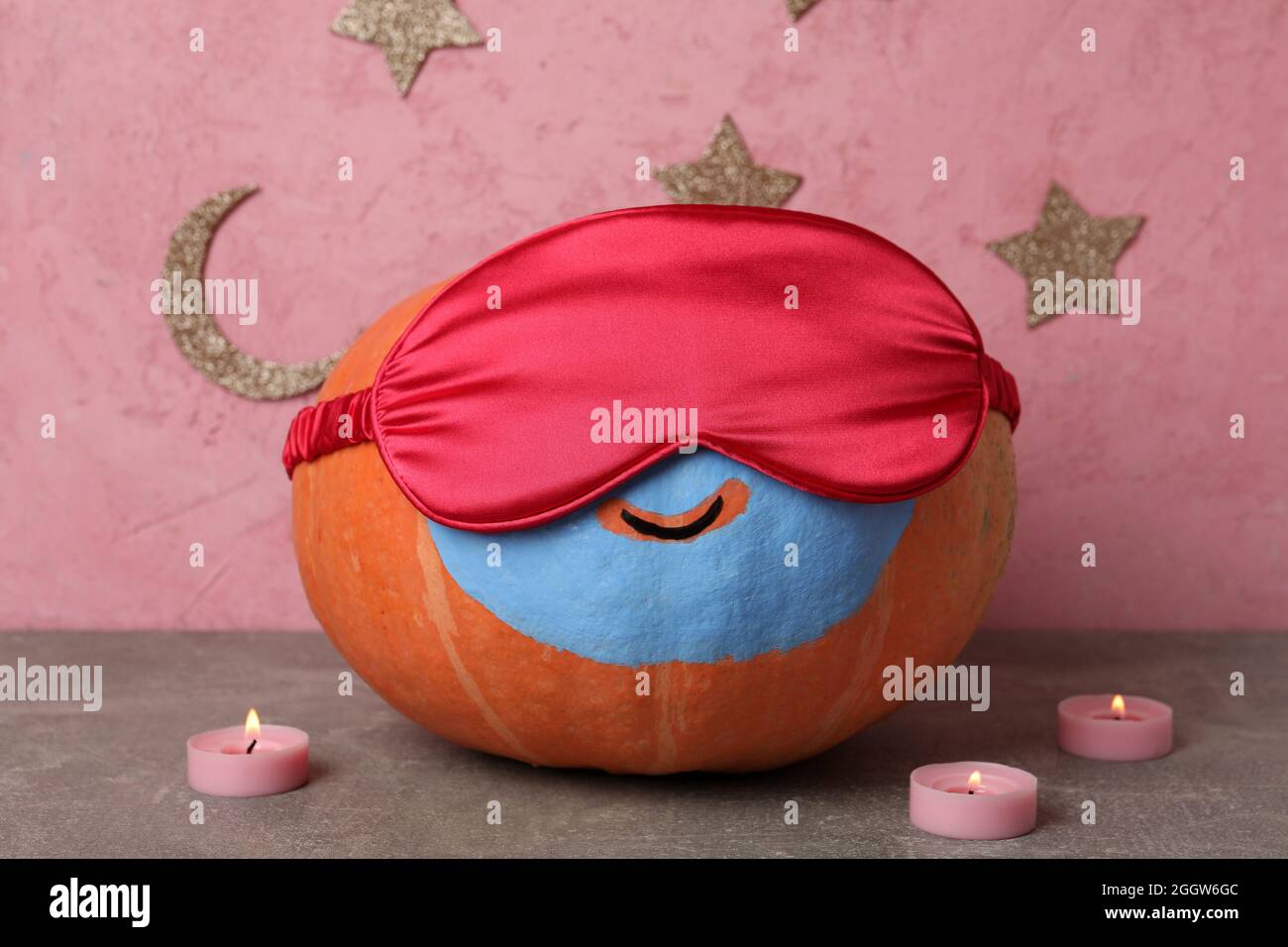 Healthy sleep concept with pumpkin against pink background Stock Photo ...