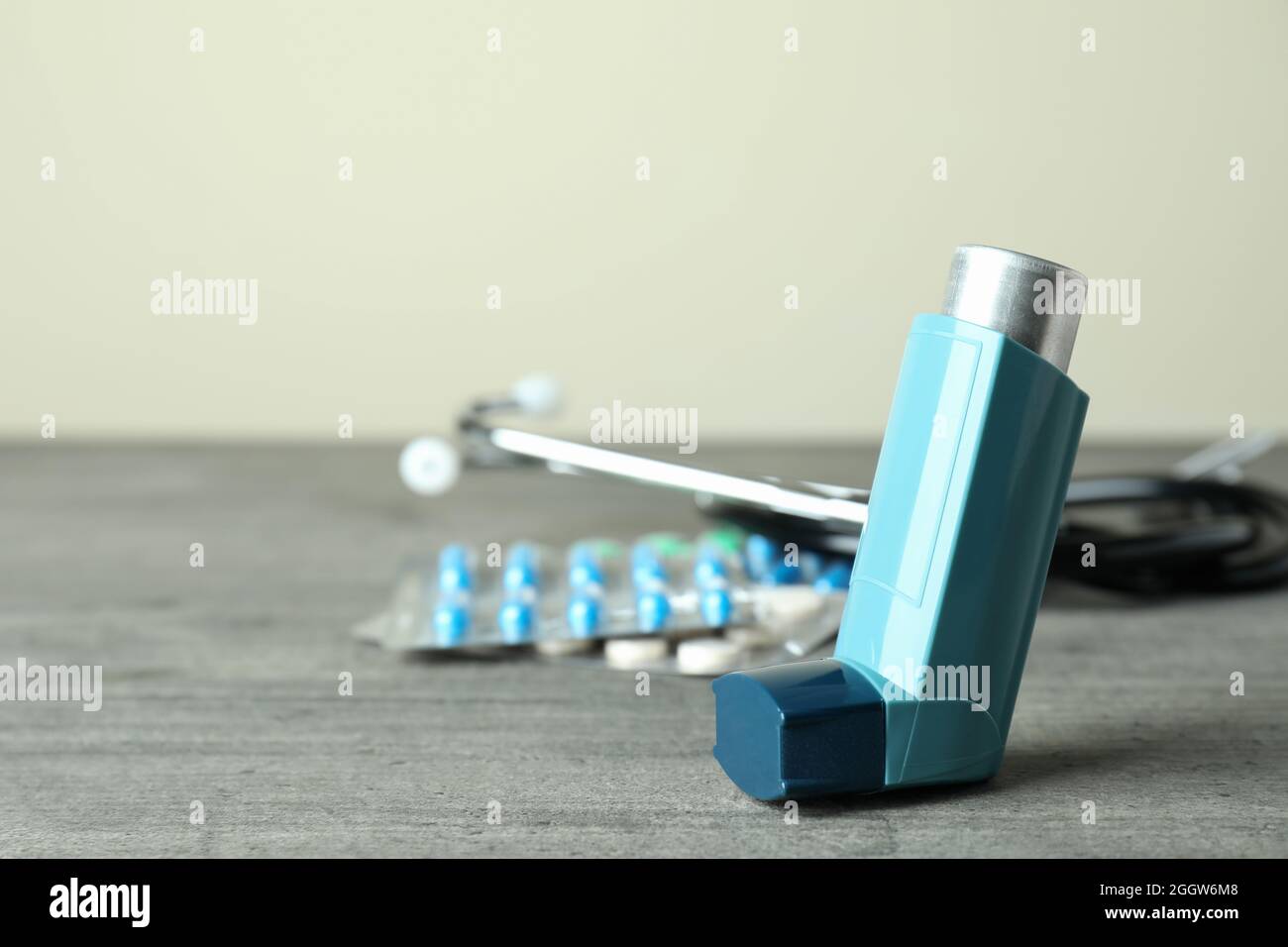 Asthma treatment accessories on gray textured table Stock Photo - Alamy