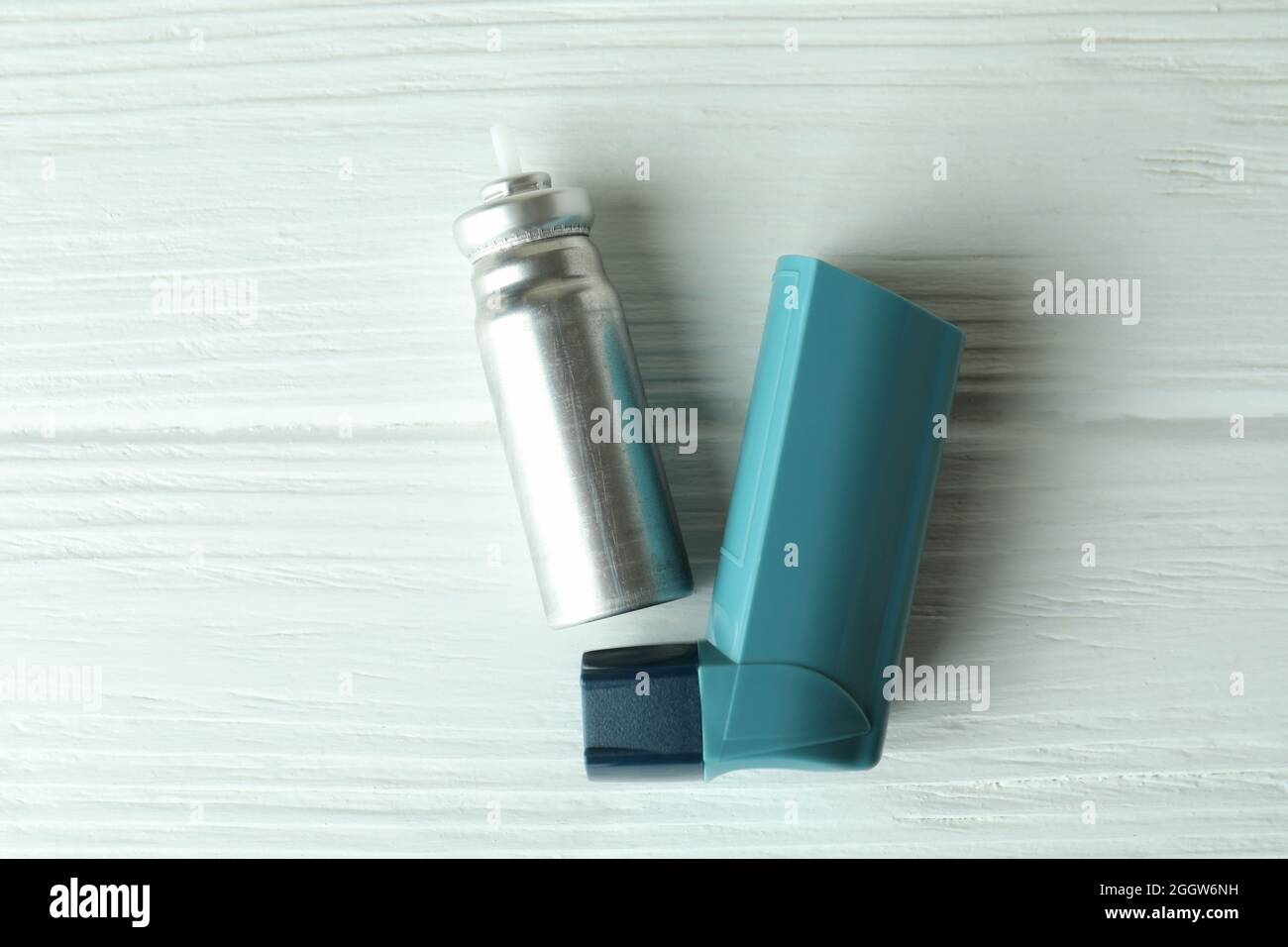 Blue asthma inhaler on white wooden table Stock Photo - Alamy
