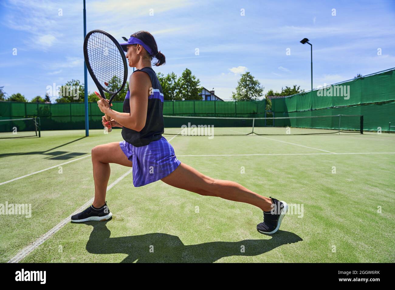 Young tennis player doing exercises on the tennis court alone Stock ...