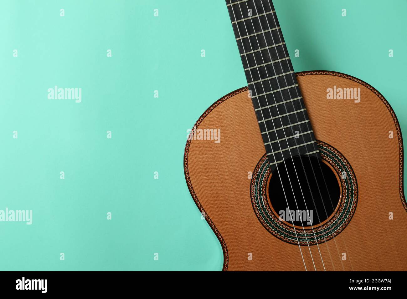 Classical guitar on mint background, space for text Stock Photo - Alamy
