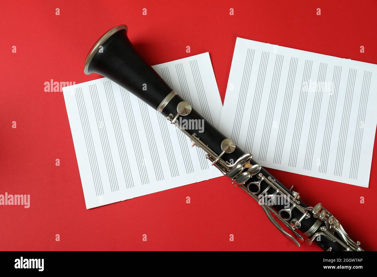 Clarinet and music sheets on red background Stock Photo - Alamy