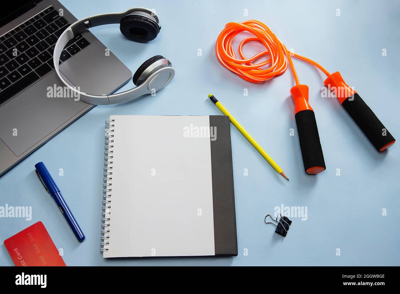 A notepad,skipping rope,pencil,pen,headphones, laptop,paper-clip and ...