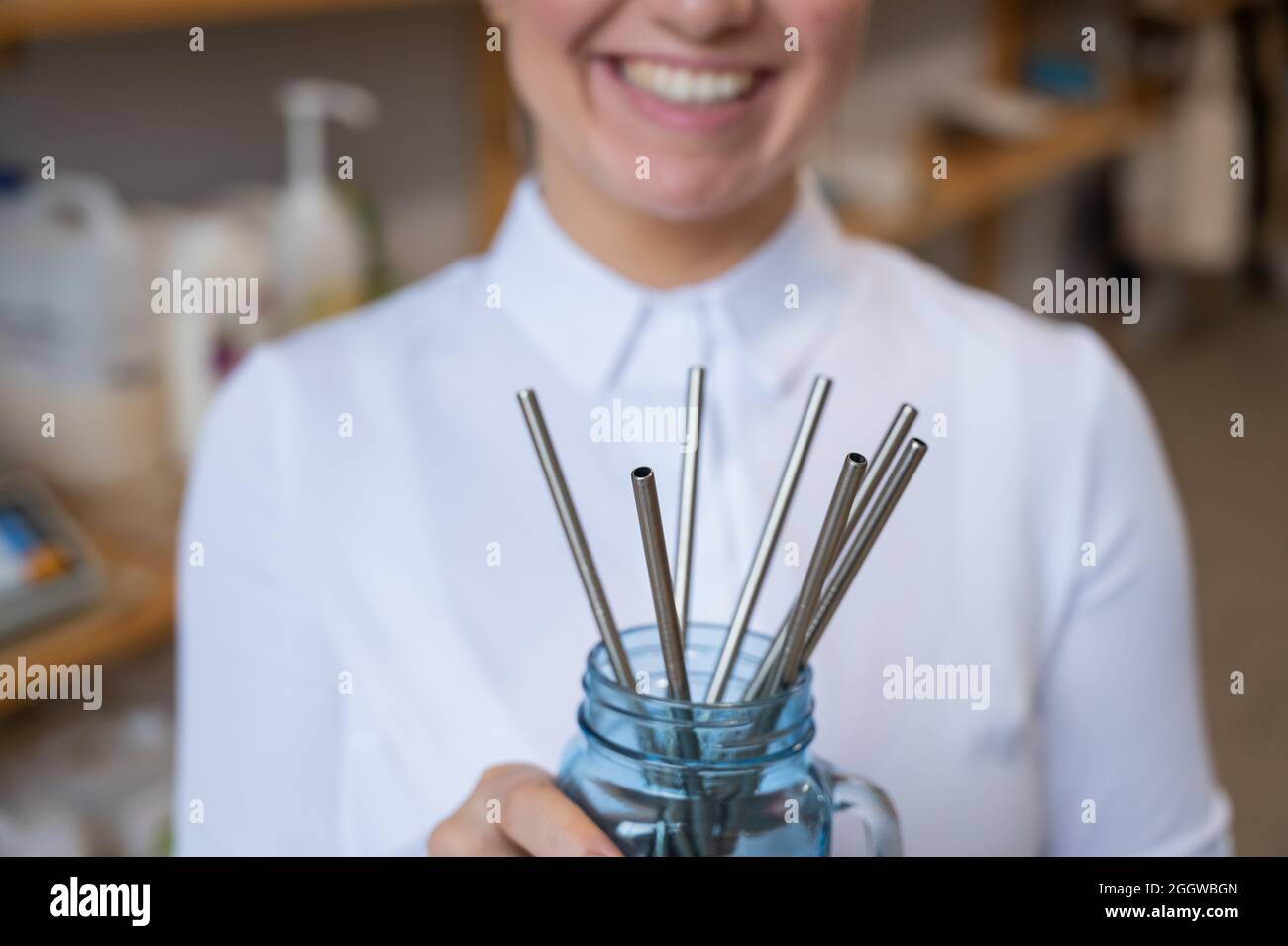 A woman holds a jar of reusable steel tubes. Eco concept Stock Photo ...