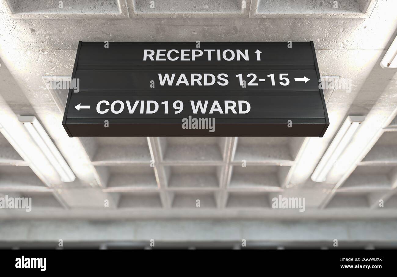 A hospital directional sign mounted on a cast concrete ceiling ...