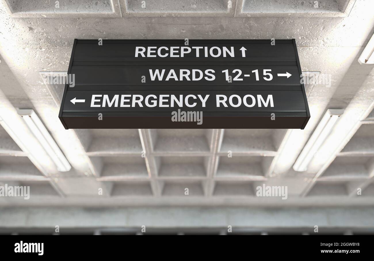 A hospital directional sign mounted on a cast concrete ceiling ...
