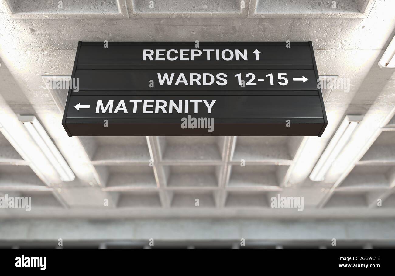 A hospital directional sign mounted on a cast concrete ceiling ...