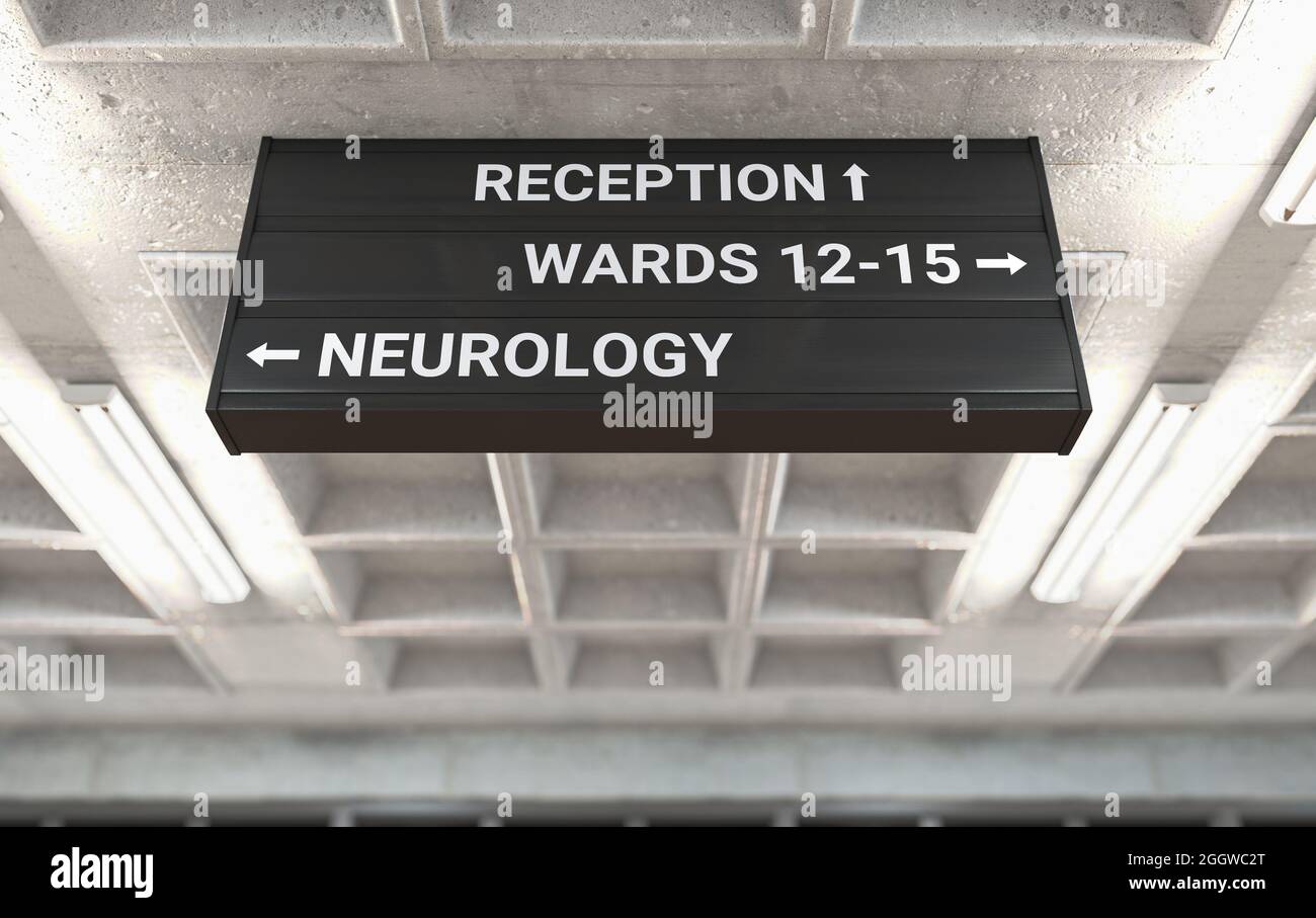A hospital directional sign mounted on a cast concrete ceiling ...