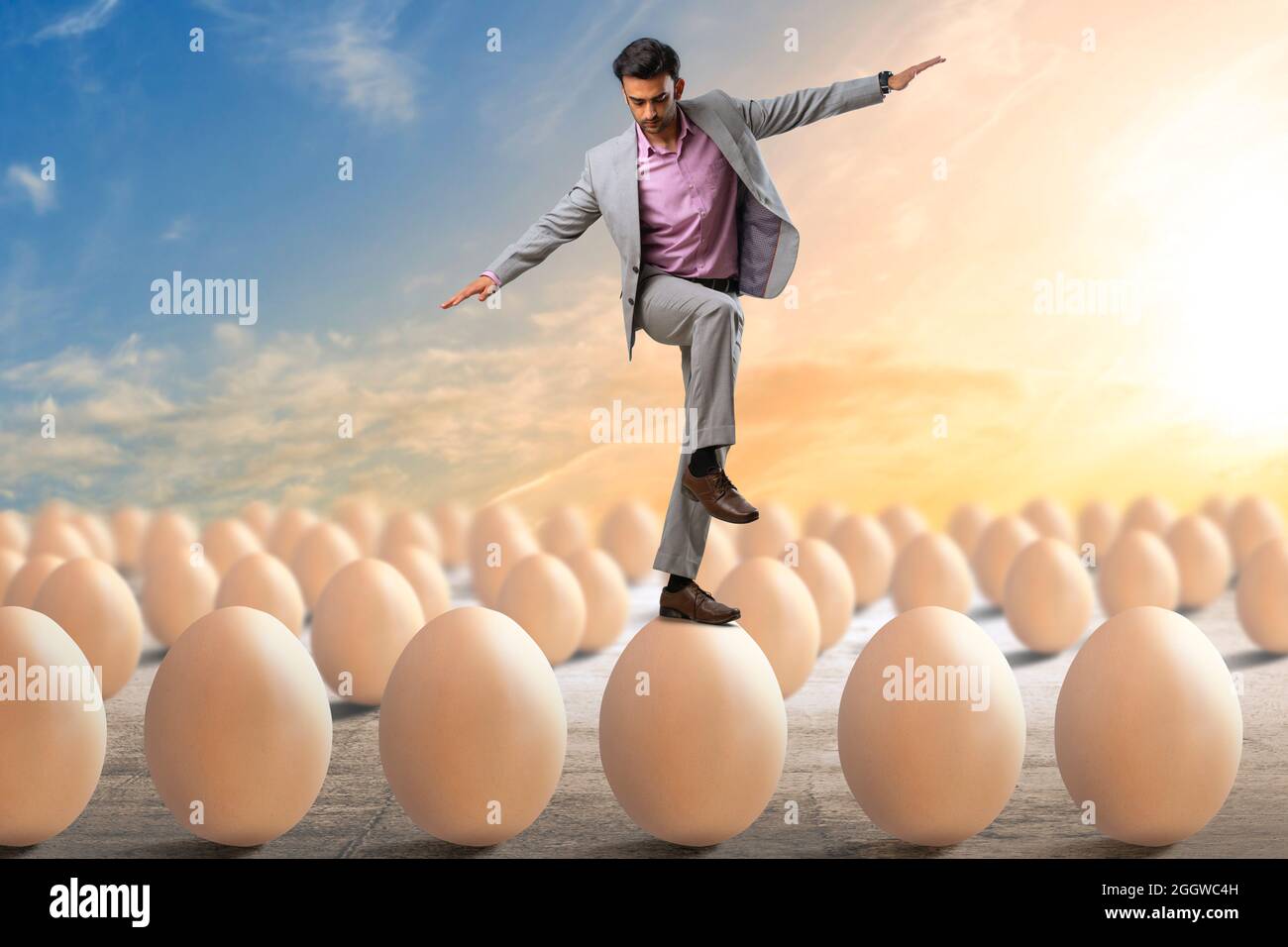 An employee in formal business trying to walk on eggs Stock Photo - Alamy