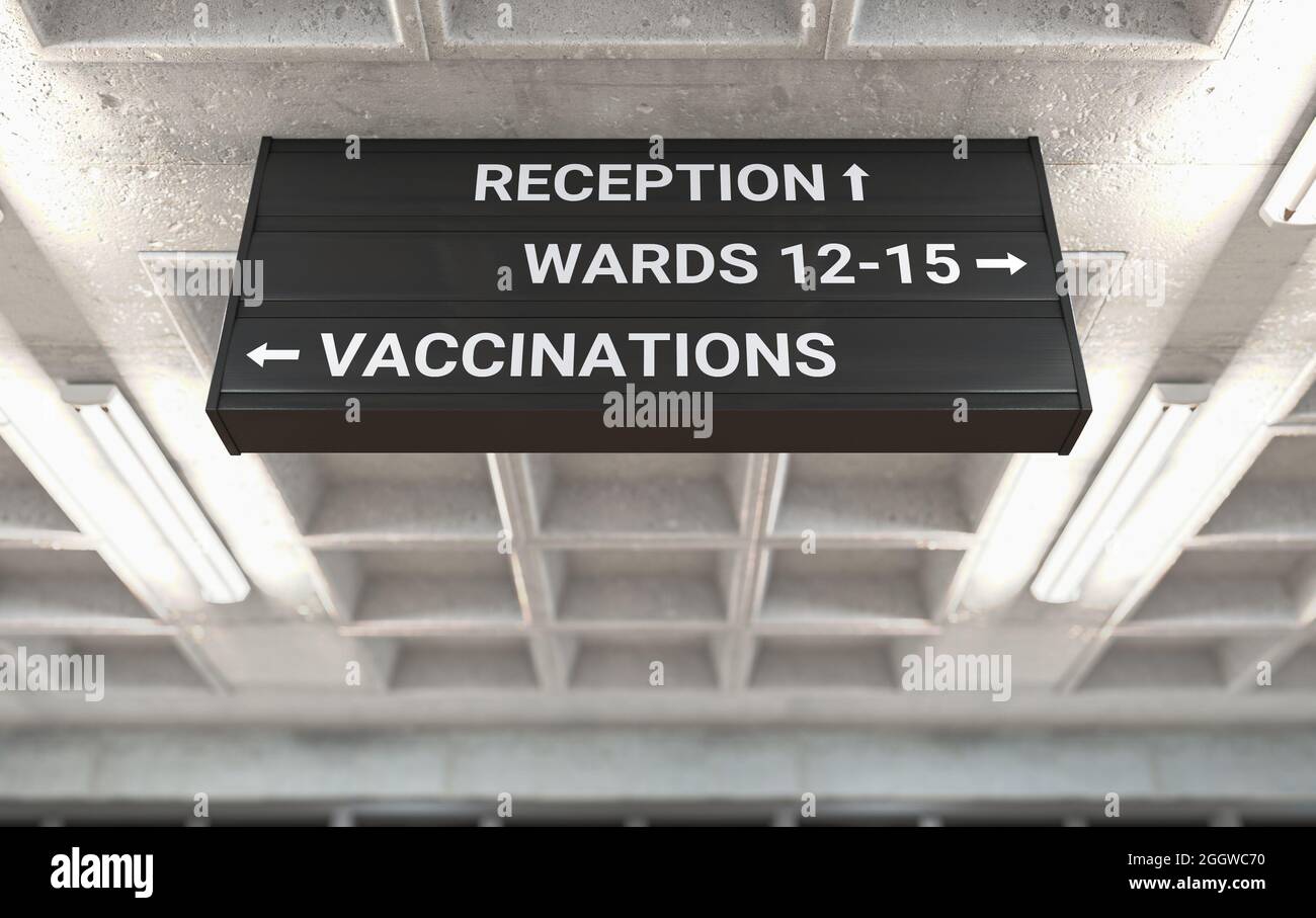 A hospital directional sign mounted on a cast concrete ceiling ...