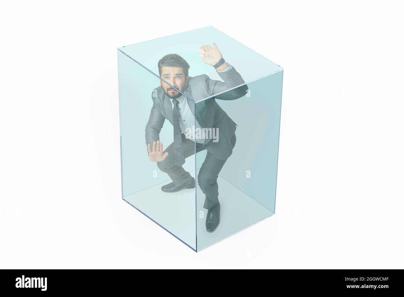 Portrait of a man in formal business suit trapped in a transparent cube ...