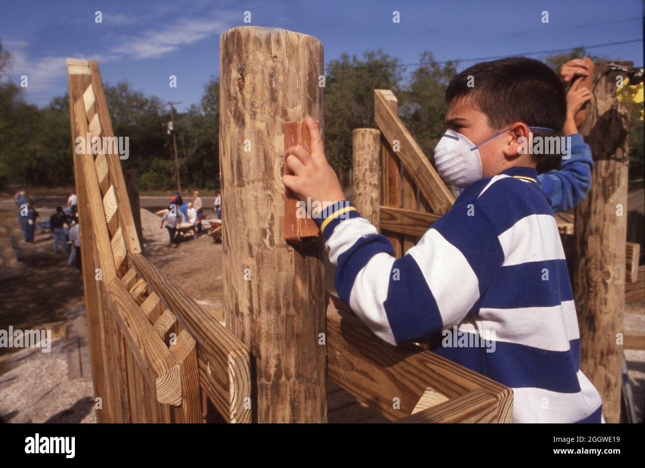 San Marcos, TX USA: Hispanic boy concentrates on sanding wood board ...