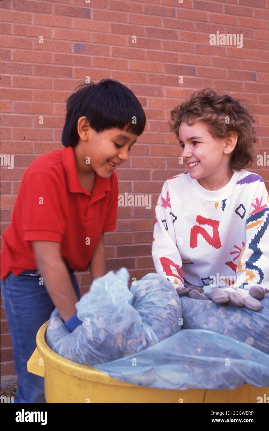 ©1990 Environmental awareness shown in children 3rd graders picking up ...