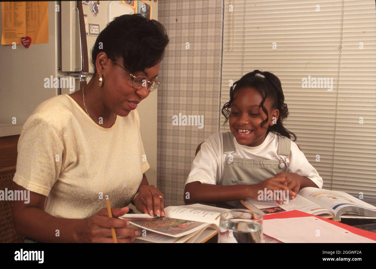 ©1997 Black mother and eight year old second grade girl review school ...