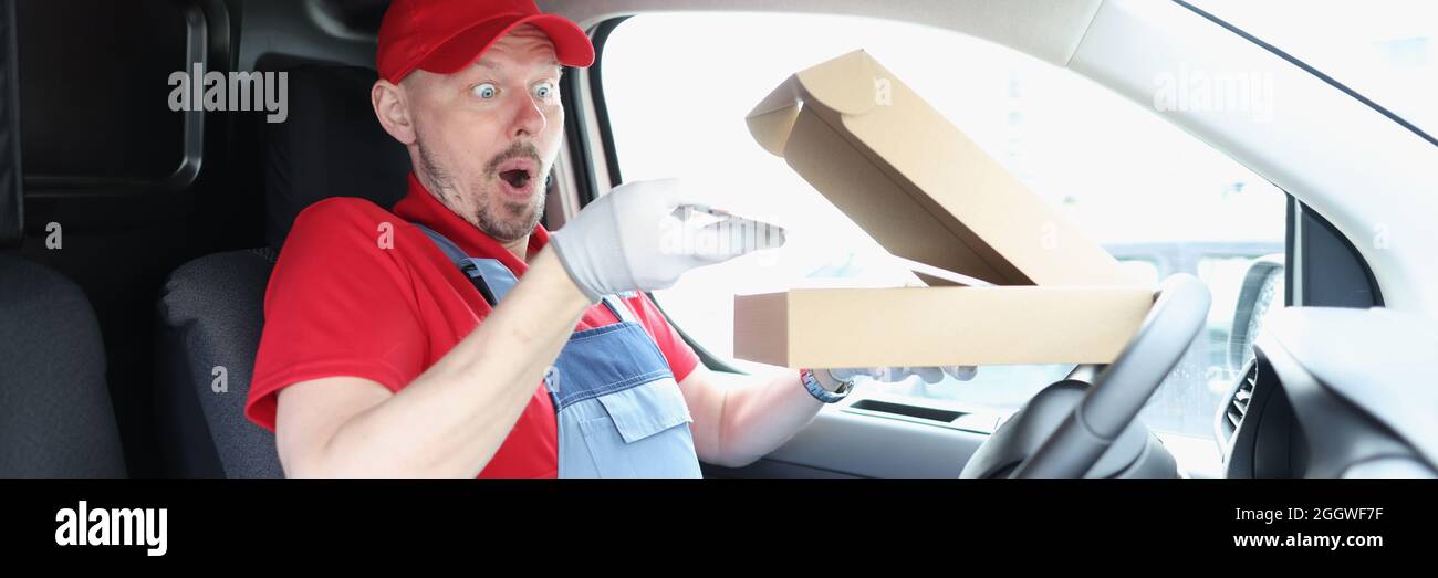 Man courier stealing digital tablet from box in car Stock Photo - Alamy