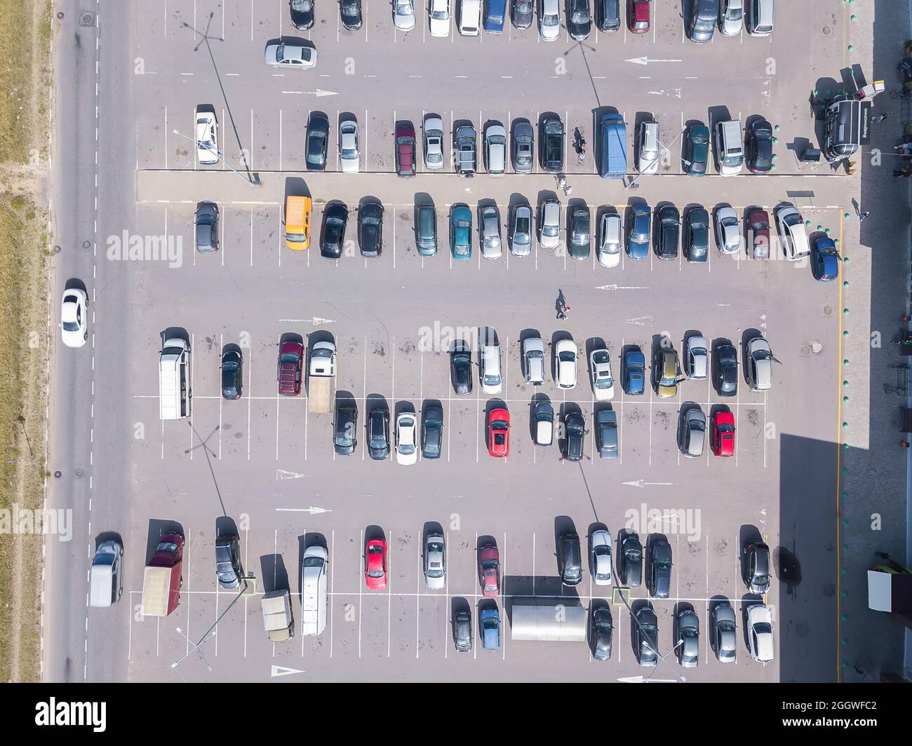 Drone view of a large car parking lot on a sunny summer day, vertical ...