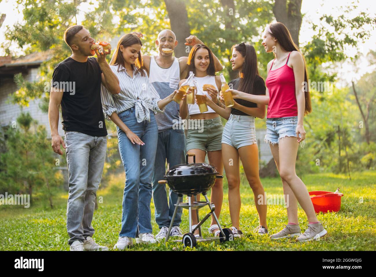 Full-length portrait of young joyfull friends hanging out in ...