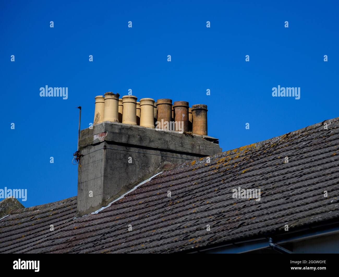 Twelve chimney pots in a stack in two colours Stock Photo - Alamy