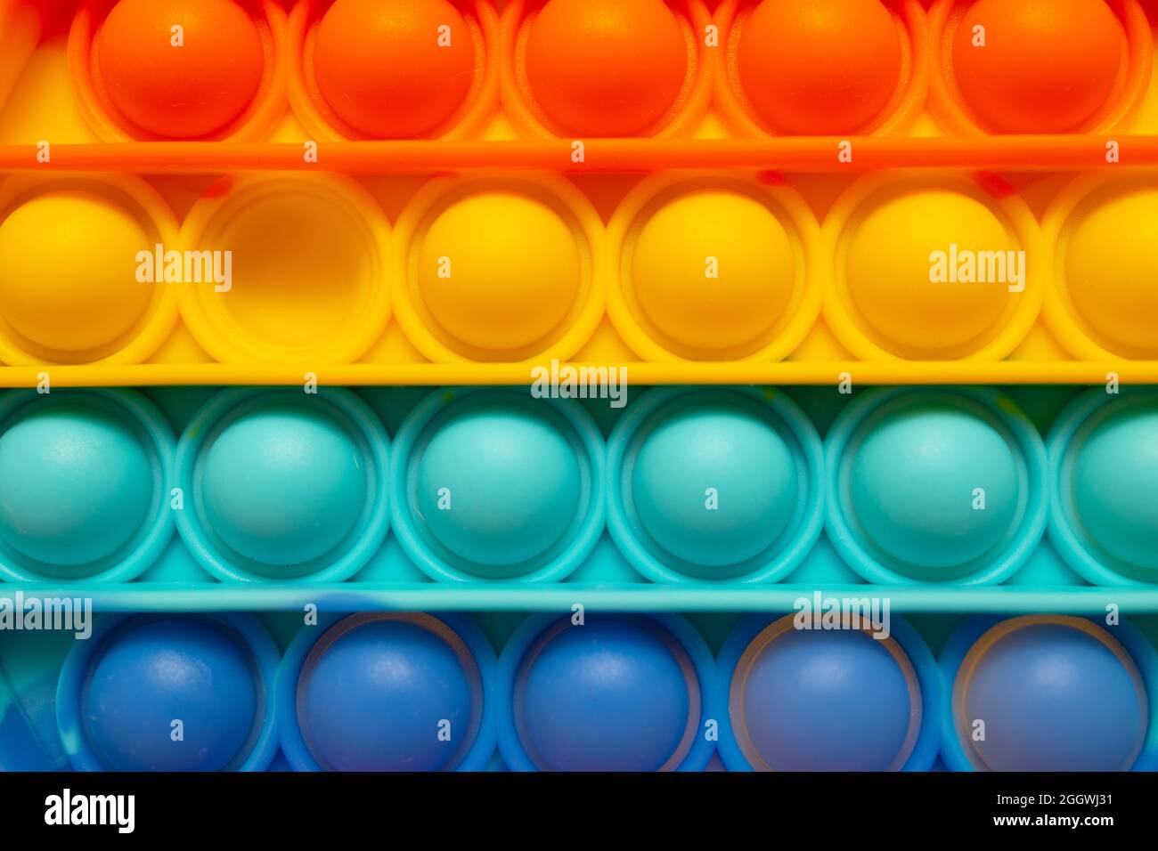 Rainbow pop it fidget toy background, closeup Stock Photo - Alamy