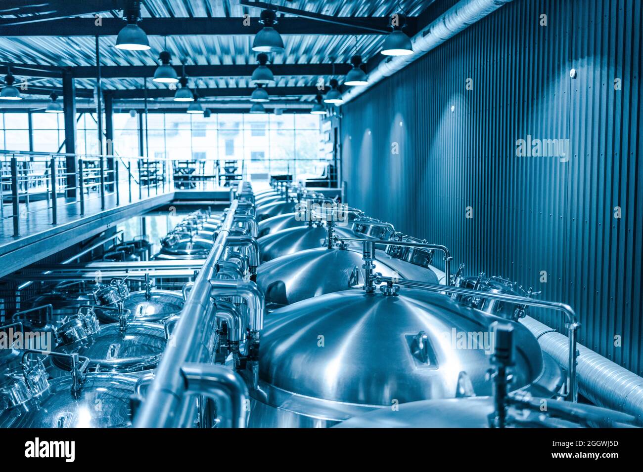 Private microbrewery. Modern beer plant with brewering kettles, tubes ...