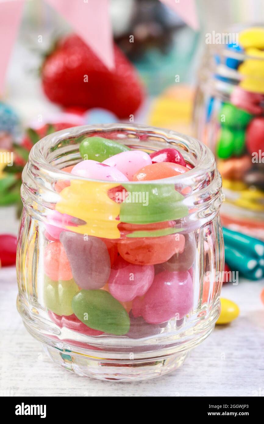 Glass jar with sweets. Party dessert Stock Photo - Alamy