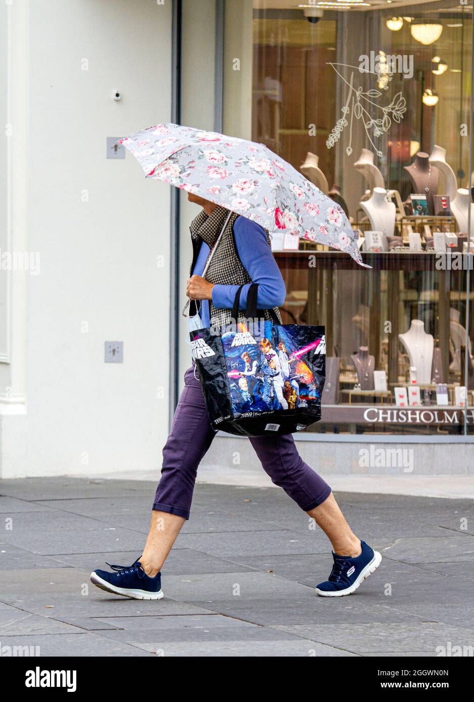 Woman holding up a brolly hi-res stock photography and images - Alamy