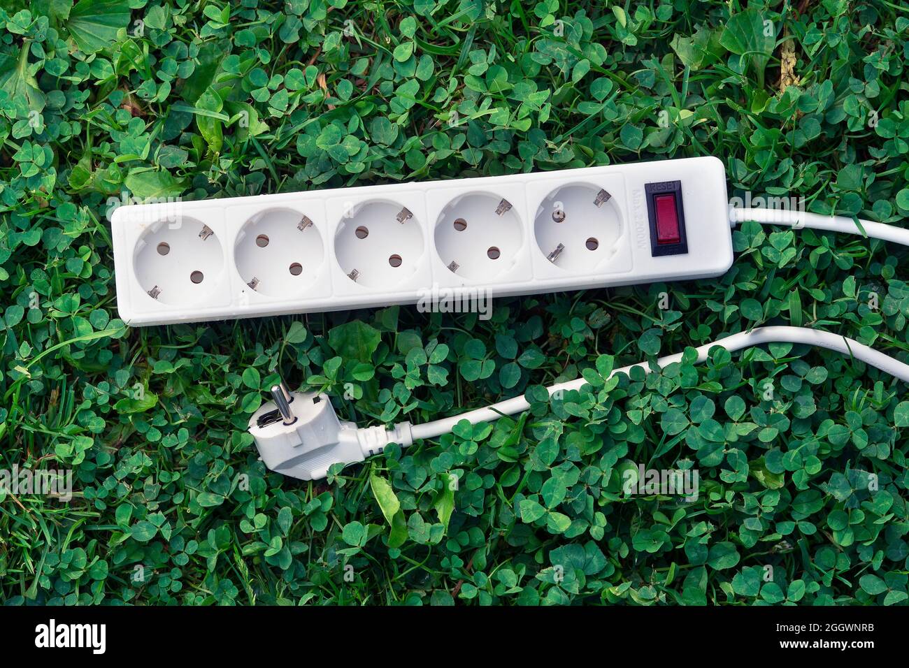 Electric power bar lying on the green grass Stock Photo - Alamy