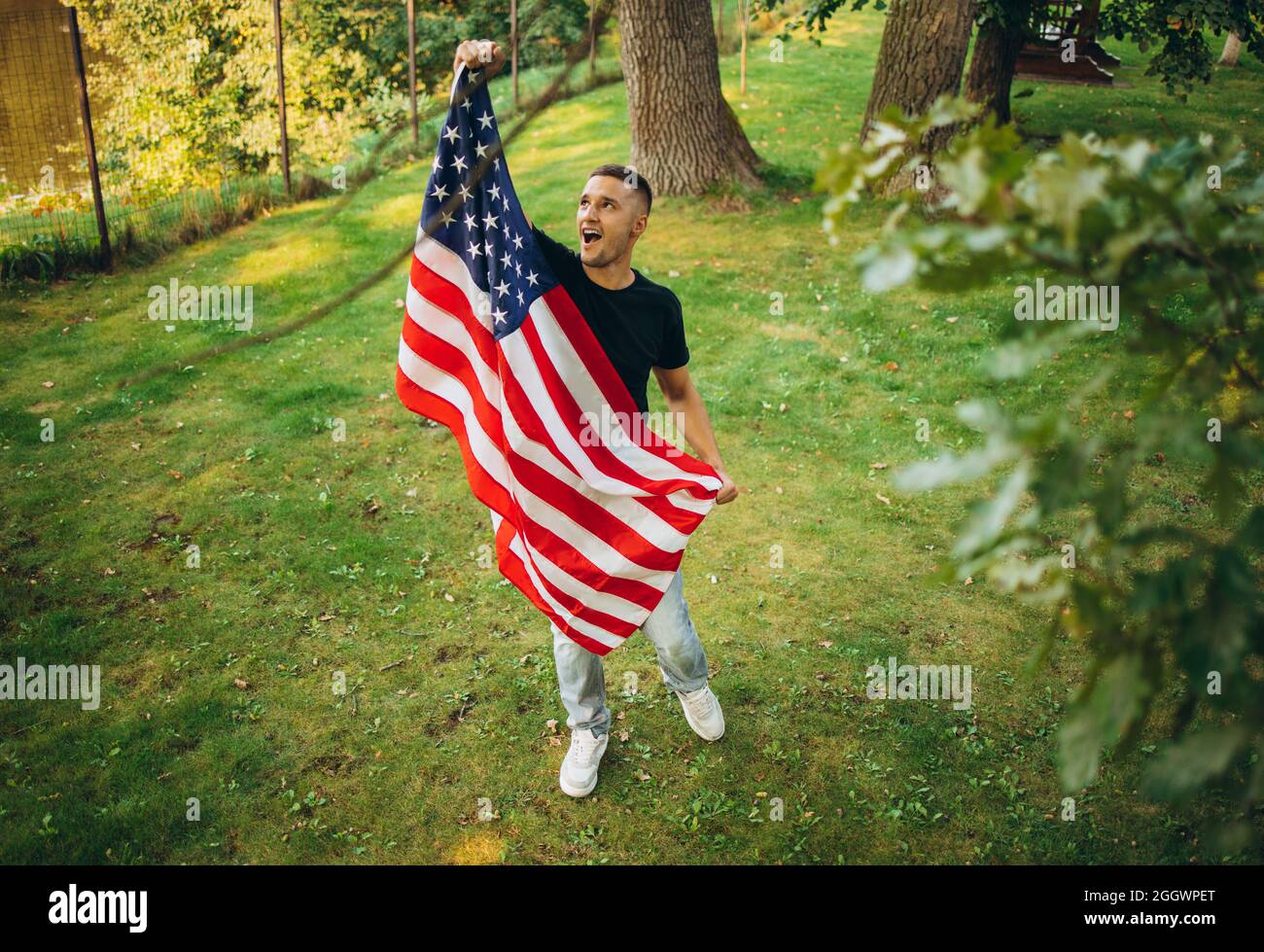 Top view portrait of young handsome man holding flag of America Stock ...