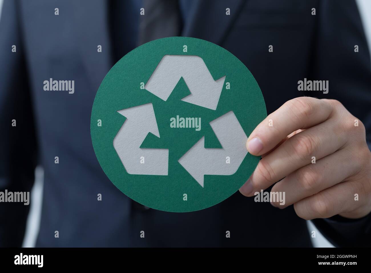 Person presenting a green recycling paper Stock Photo - Alamy