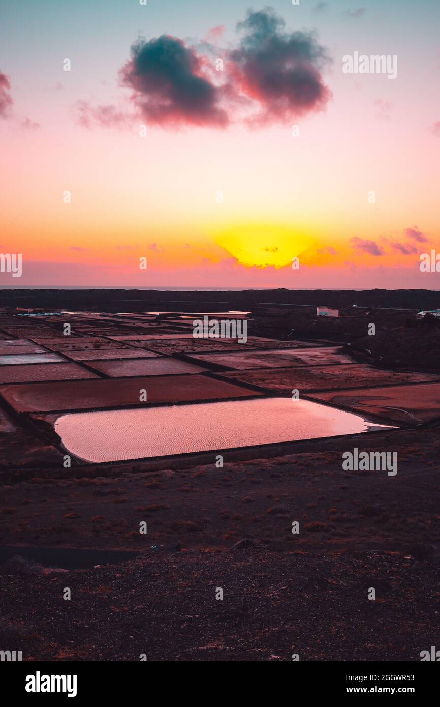 Vertical shot of natural salt evaporation ponds at scenic sunset Stock ...