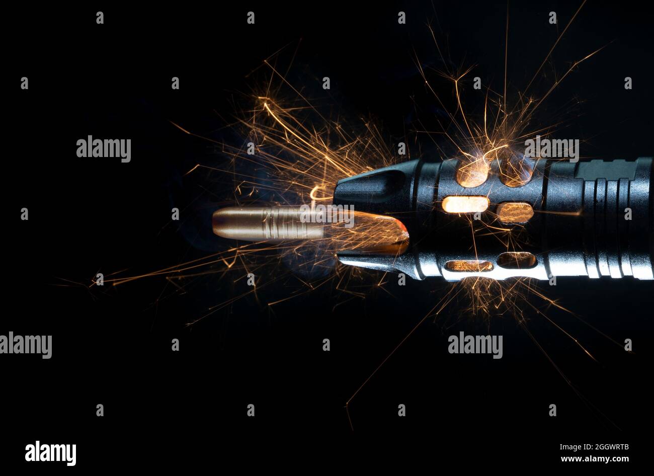 Copper bullet with smoke and sparks coming from the barrel of an ...
