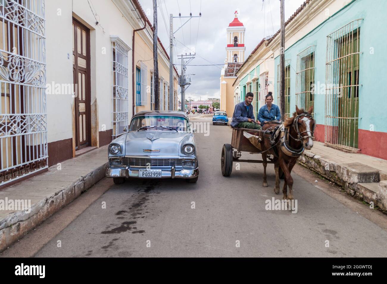 REMEDIOS, CUBA - FEB 12, 2016: Horse carriage and a vintage Chevrolet ...