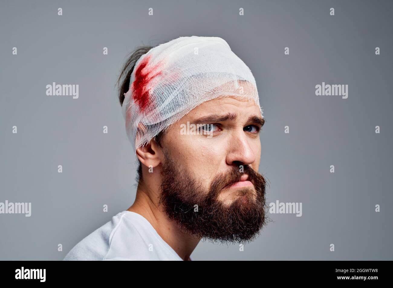 Man bandaged head and hand blood light background Stock Photo - Alamy