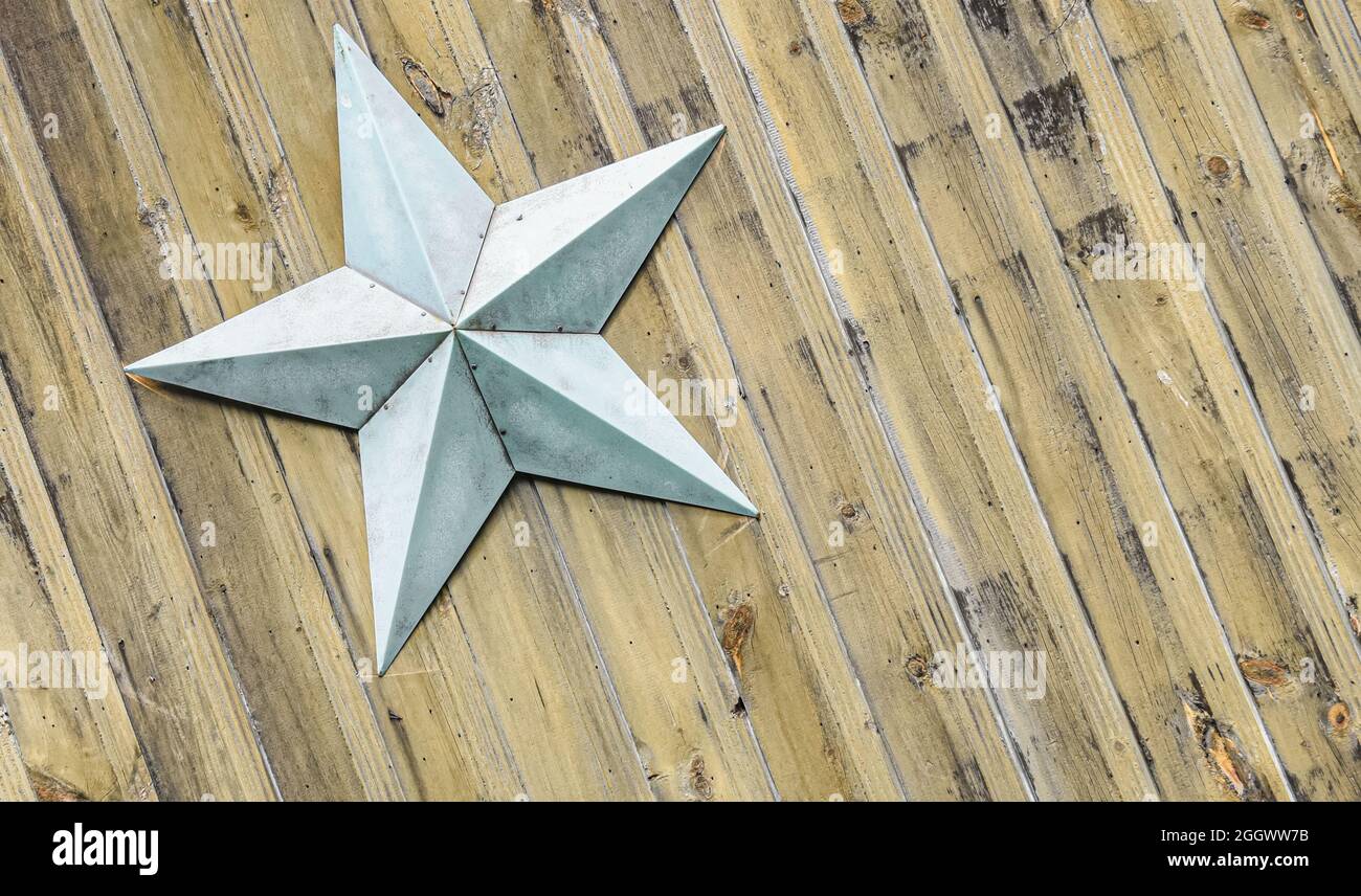 Light blue star on a background of diagonal rustic yellow pine ...