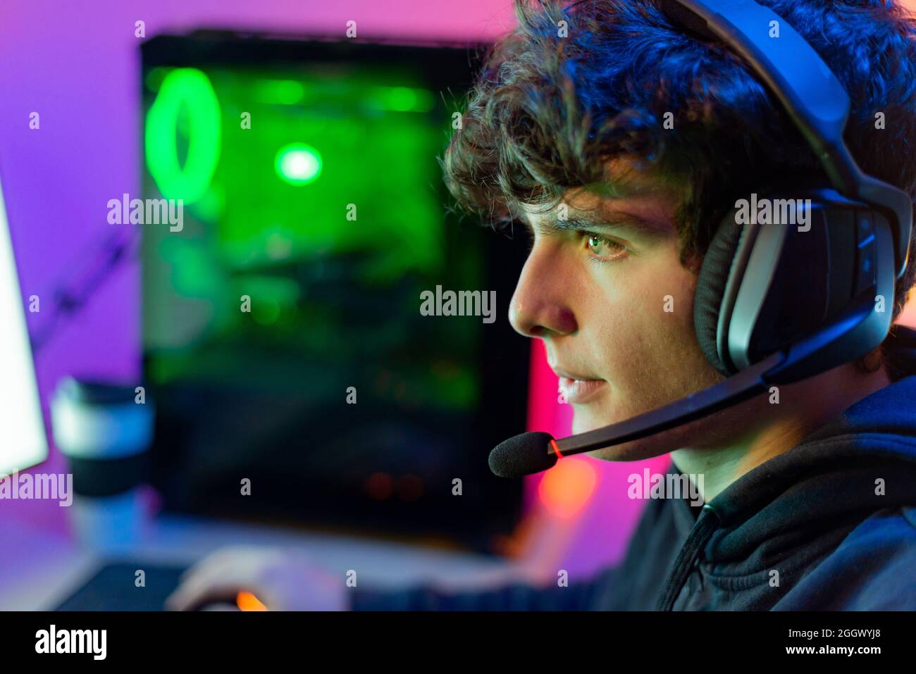 Man with gaming headset playing computer game Stock Photo - Alamy
