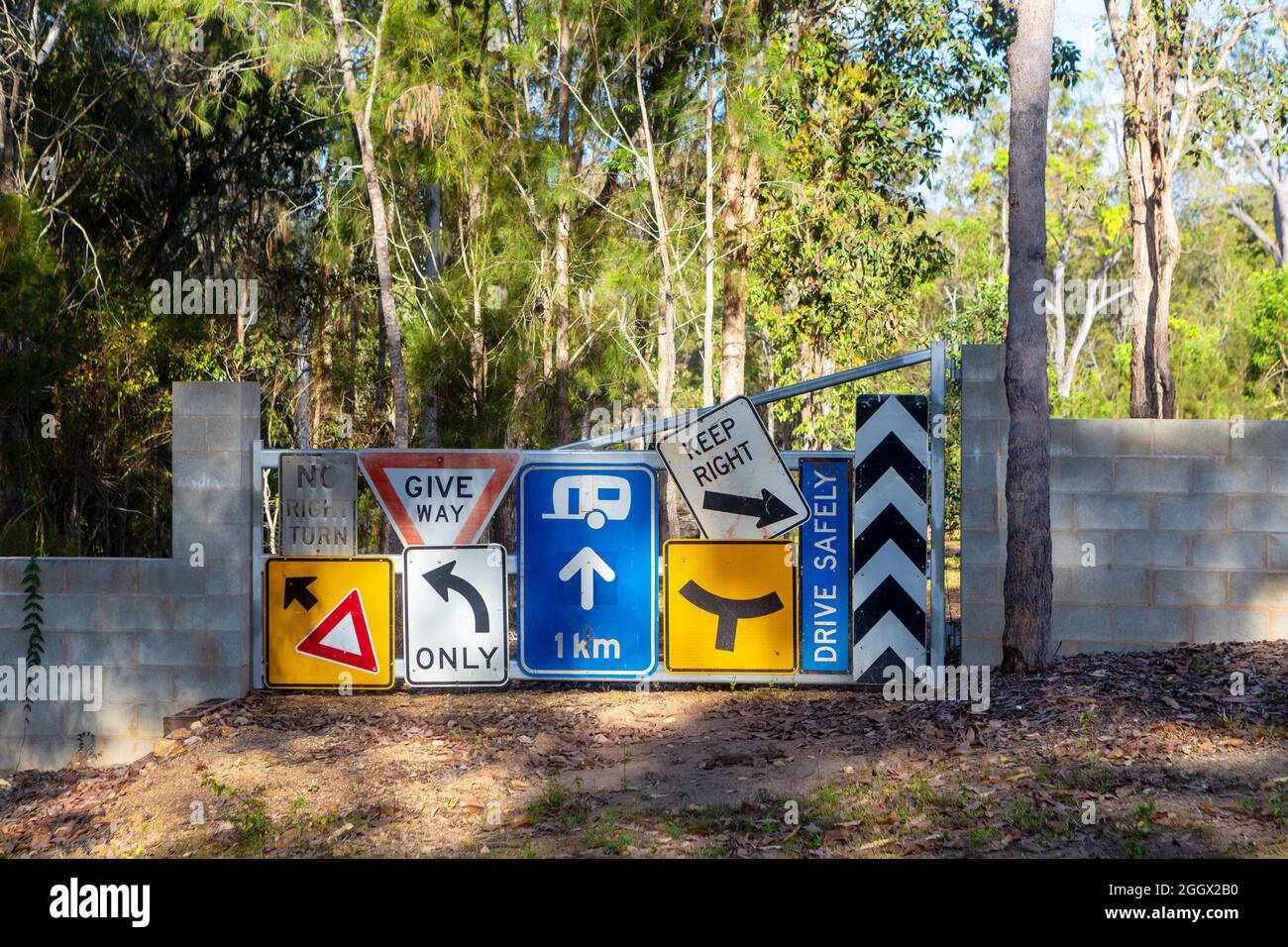 Random signs attached to a farm gate Stock Photo - Alamy
