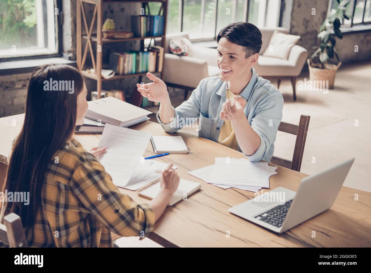 Photo of two college students prepare for exam together talking ...
