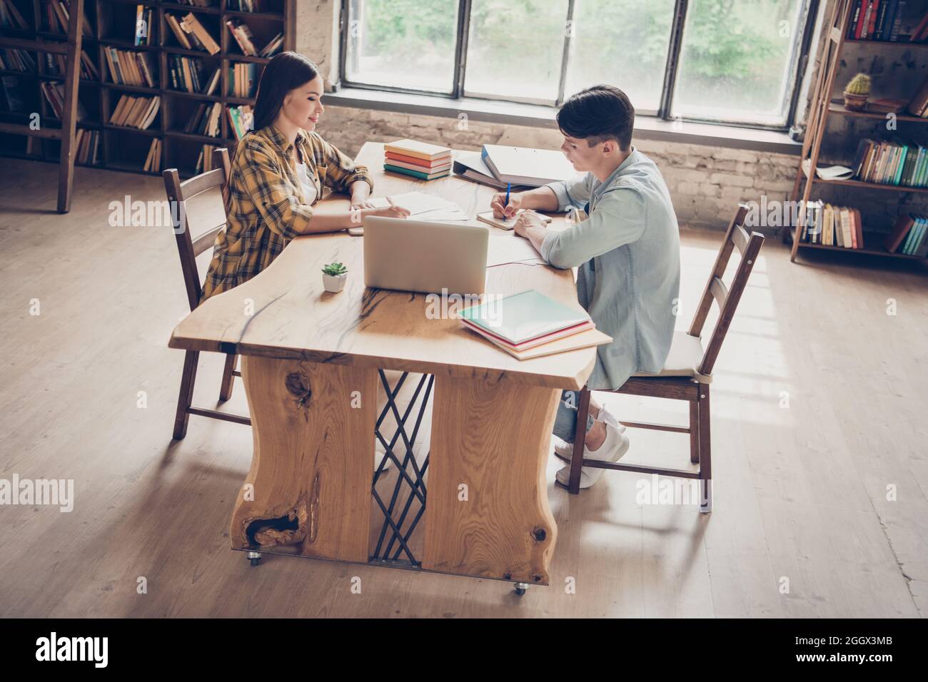 Portrait of two attractive focused diligent smart people researching ...