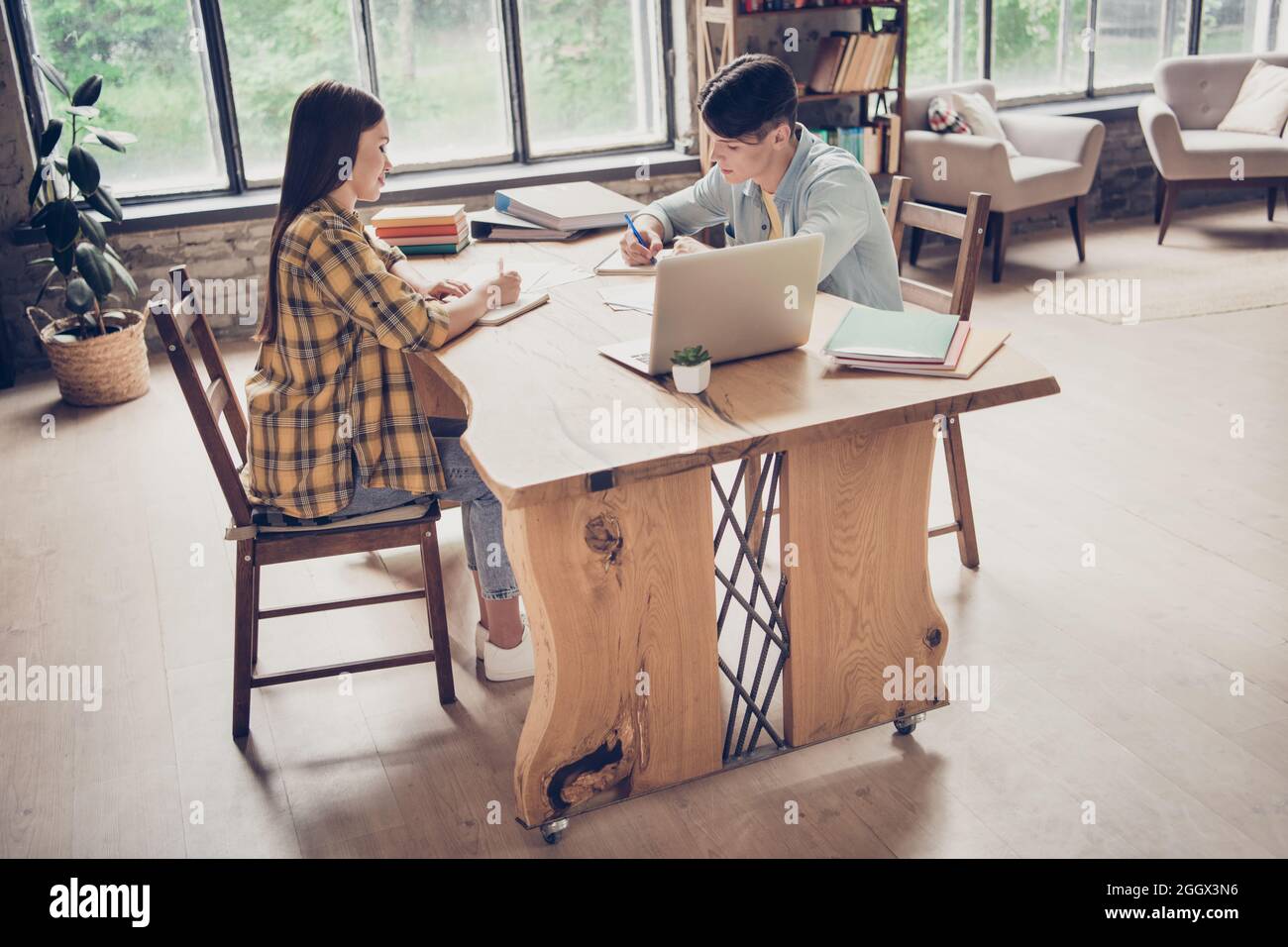 Full size photo of two focused concentrated university students leaning ...