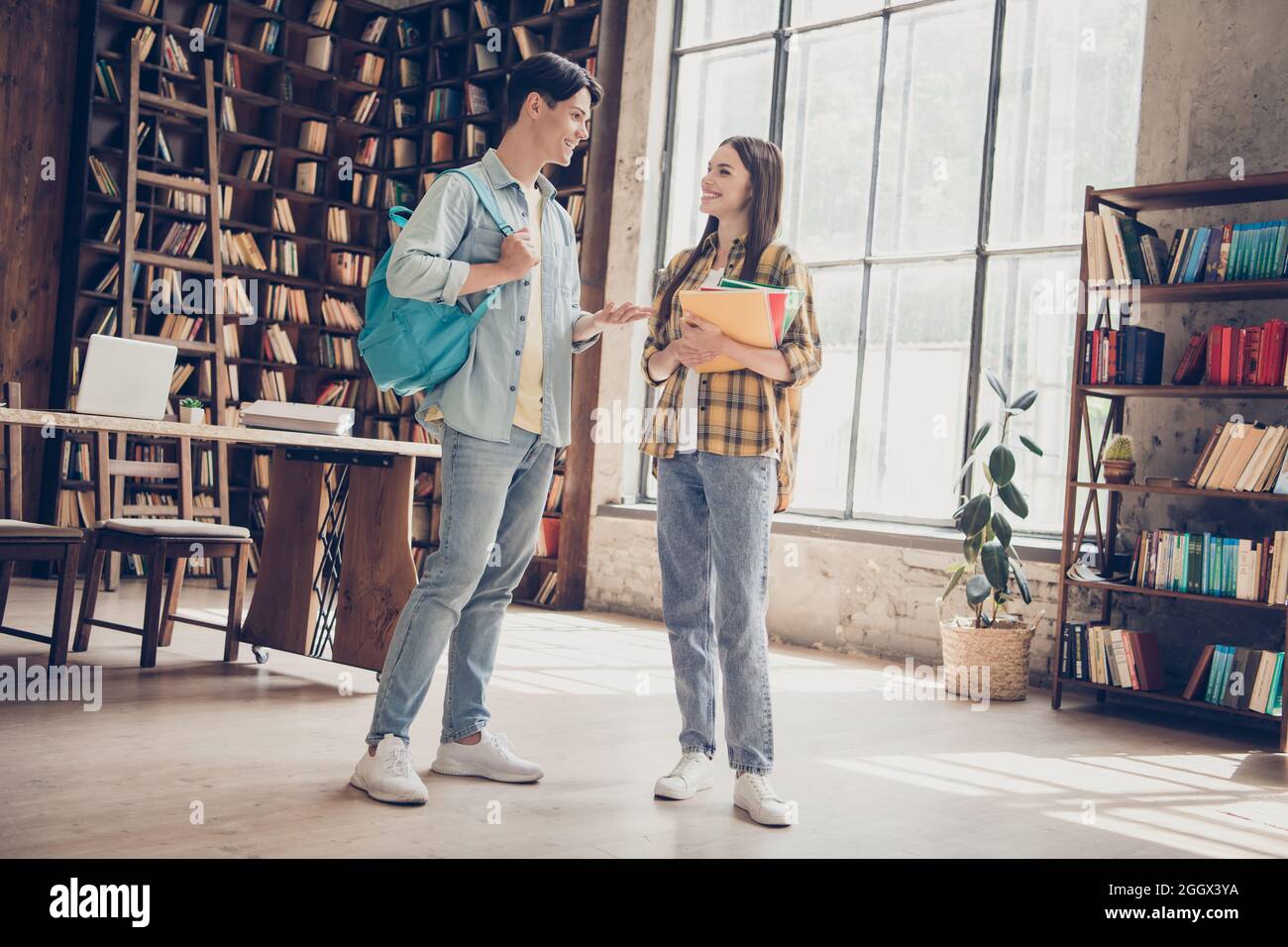 Full size photo of two smiling good mood cheerful classmates talking ...