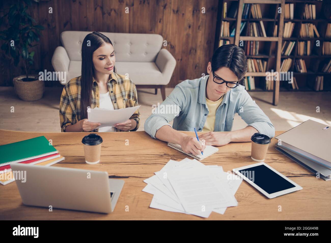 Portrait of two attractive creative focused busy friends friendship ...