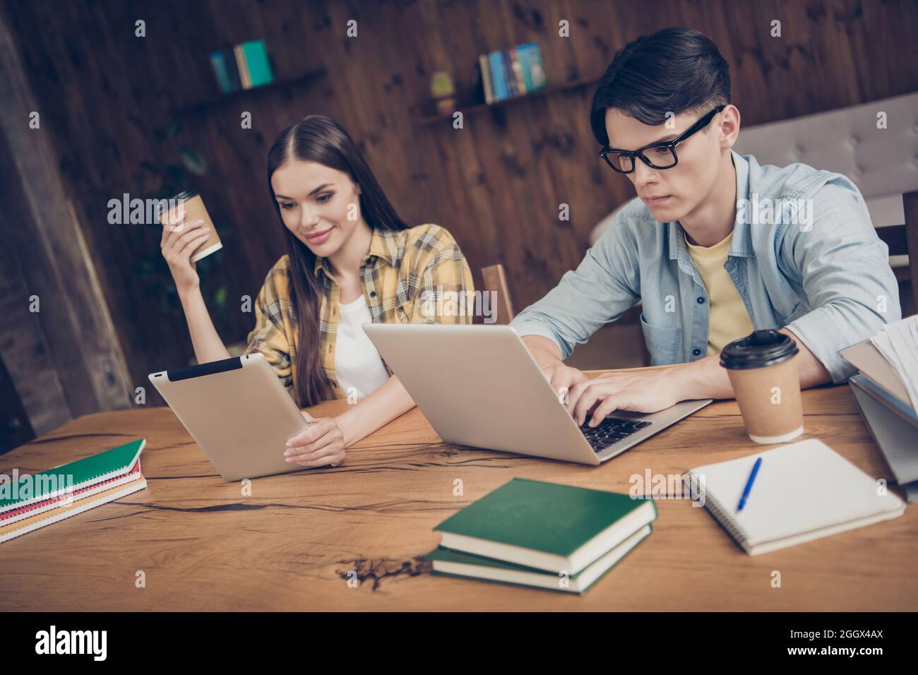 Portrait of two attractive creative friends friendship doing task ...