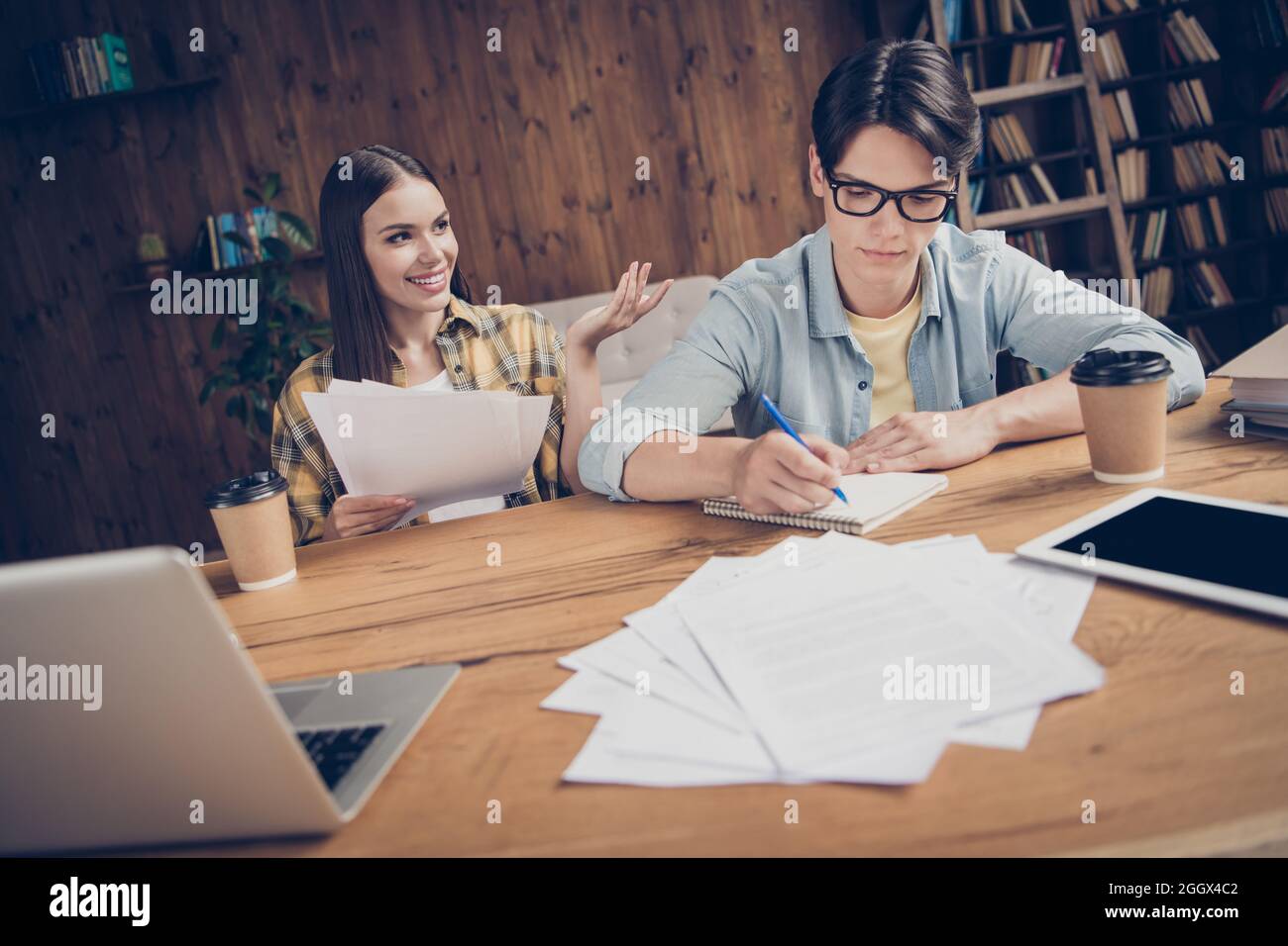 Portrait of two classmates best friends preparing for exams guy writing ...