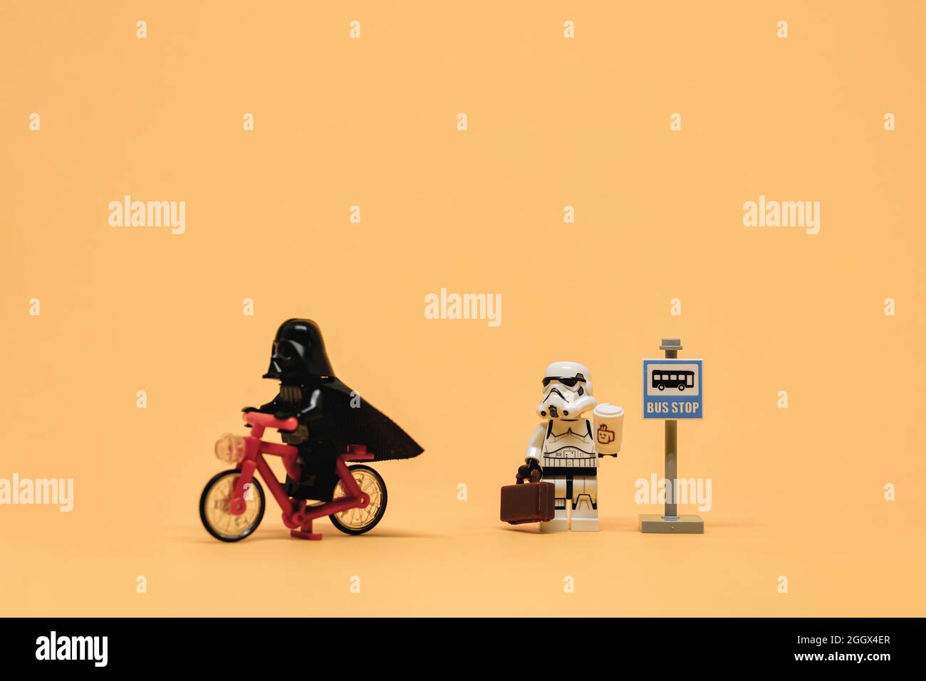 Darth Vader on bicycle passing public bus stop. Public transport ...