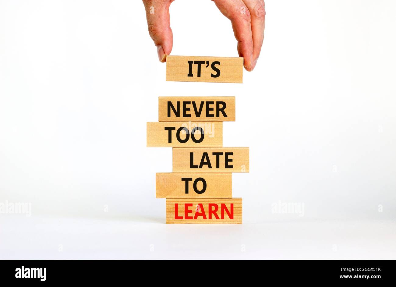 Learn symbol. Wooden blocks with words 'It is never too late to learn ...