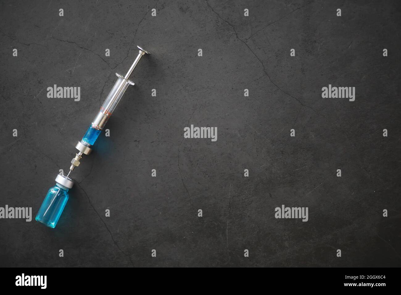 small jars with injection and syringe for injection on blue background ...