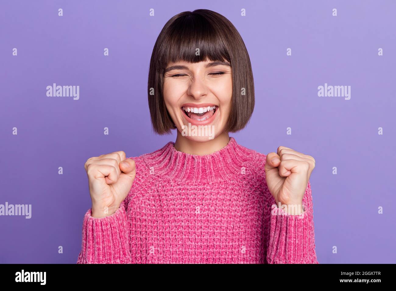Portrait of young smiling screaming female closed eyes raise fists in ...